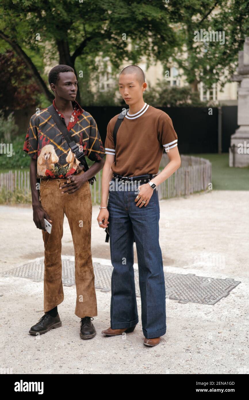 Trendy women and men pose for street snap during the Paris Fashion Week ...