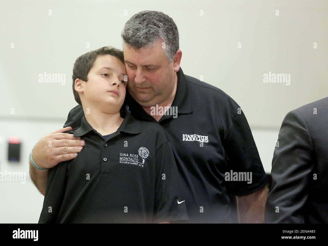 Tony Montalto comforts his son Anthony, 13, as they prepare to listen ...