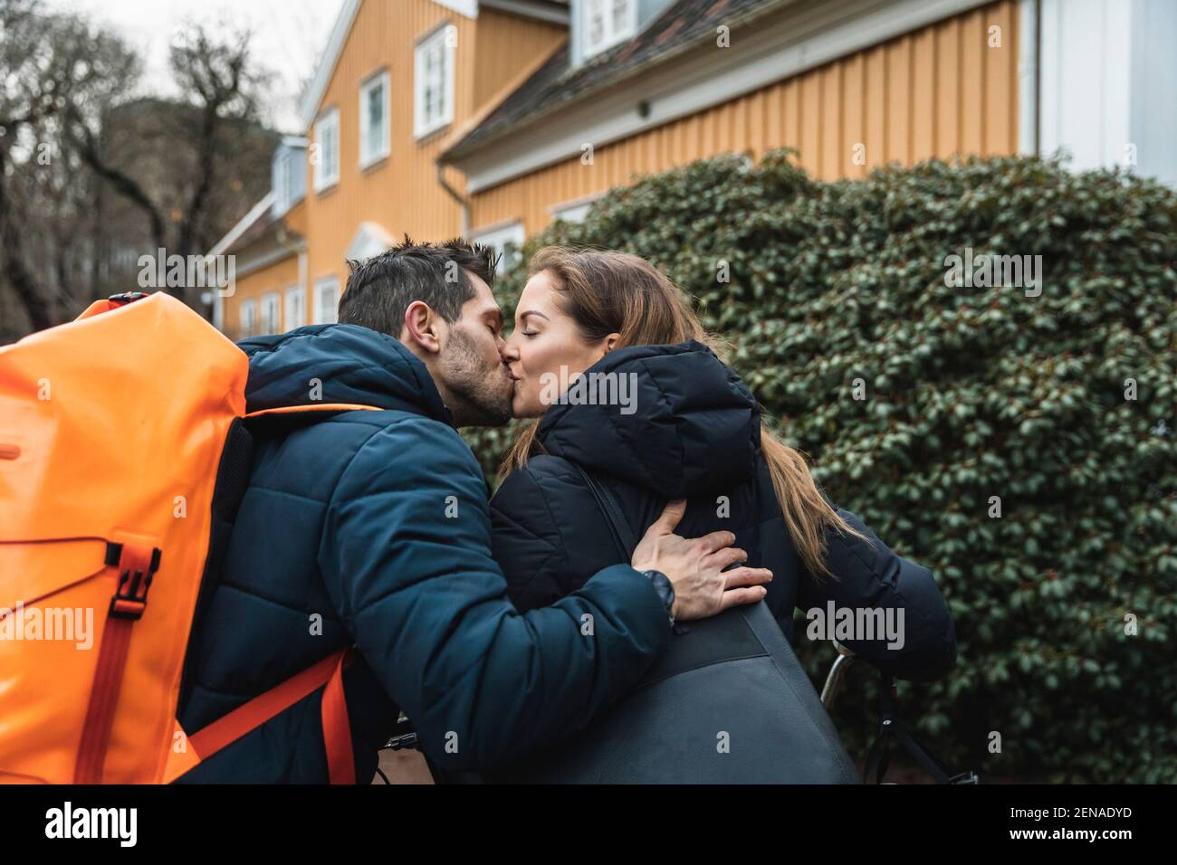 Happy couple kissing each other at back yard Stock Photo - Alamy