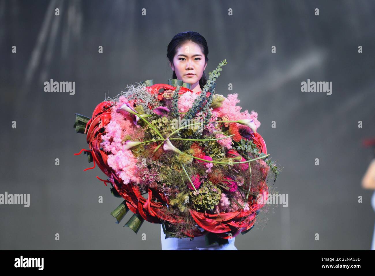 A model displays a new creation decorated with flowers at a floral ...