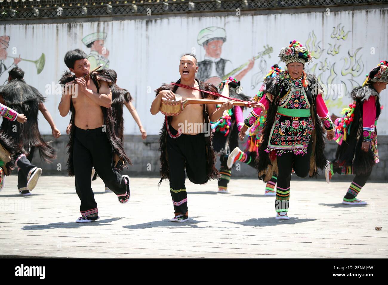 Yi People sing and dance during intangible cultural heritage demonstration at Qingyun village ...