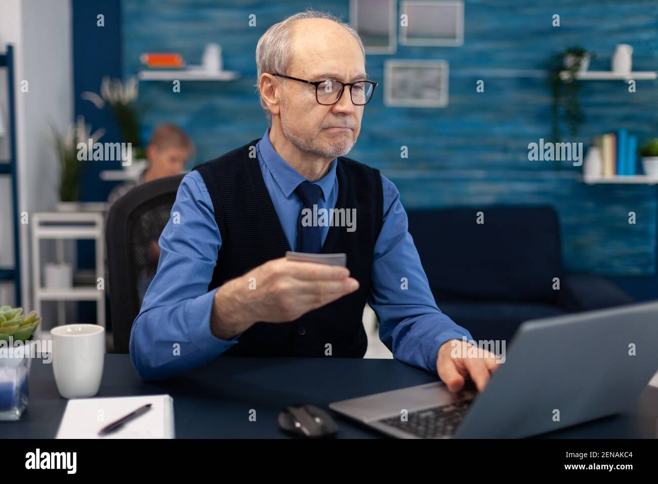 Senior man using credit card to check bank account. Elderly man ...