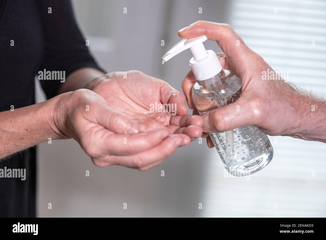 Female hand pressing on sanitizer alcohol gel bottle; prevention of ...