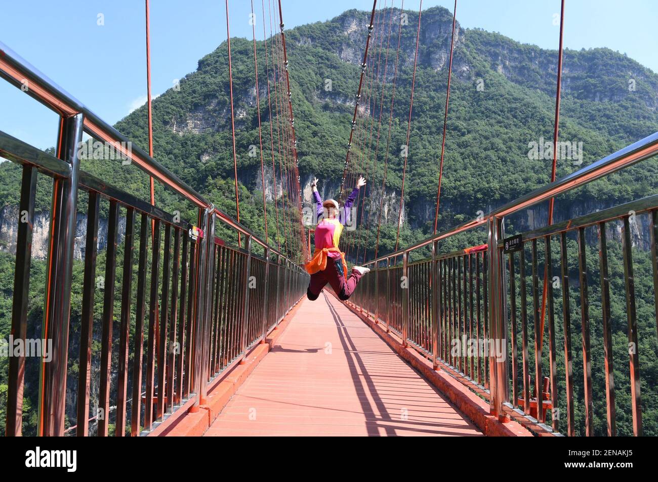 Tourists pose for photos on the 220-meter-long glass-bottomed ...