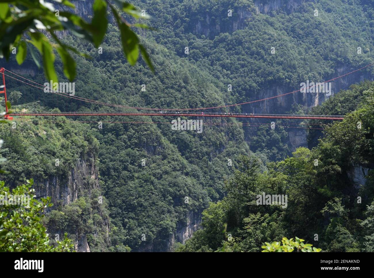 Tourists pose for photos on the 220-meter-long glass-bottomed ...