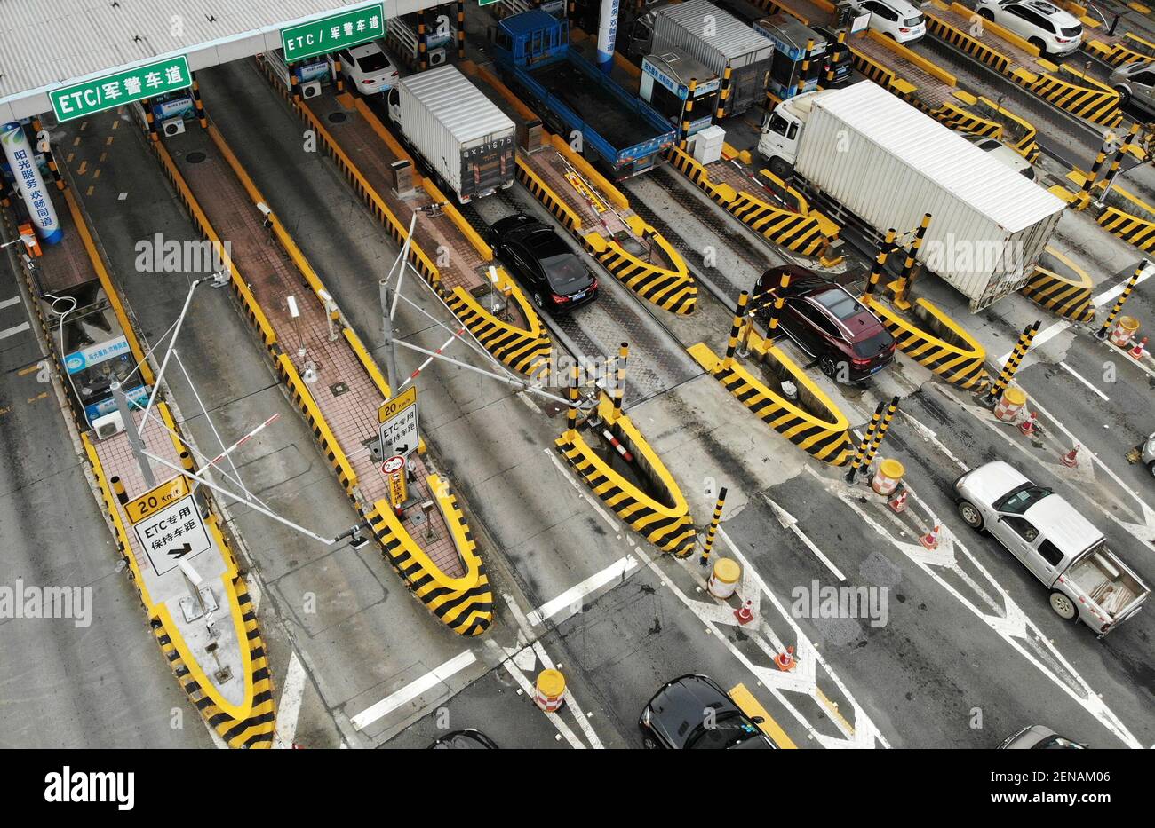 --FILE--Vehicles queue up to pass through a toll station on an ...