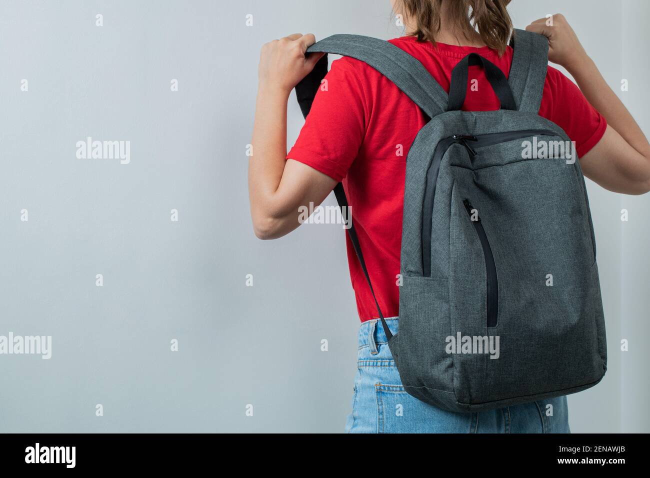 Schoolkid holding her backpack in the shoulders Stock Photo - Alamy