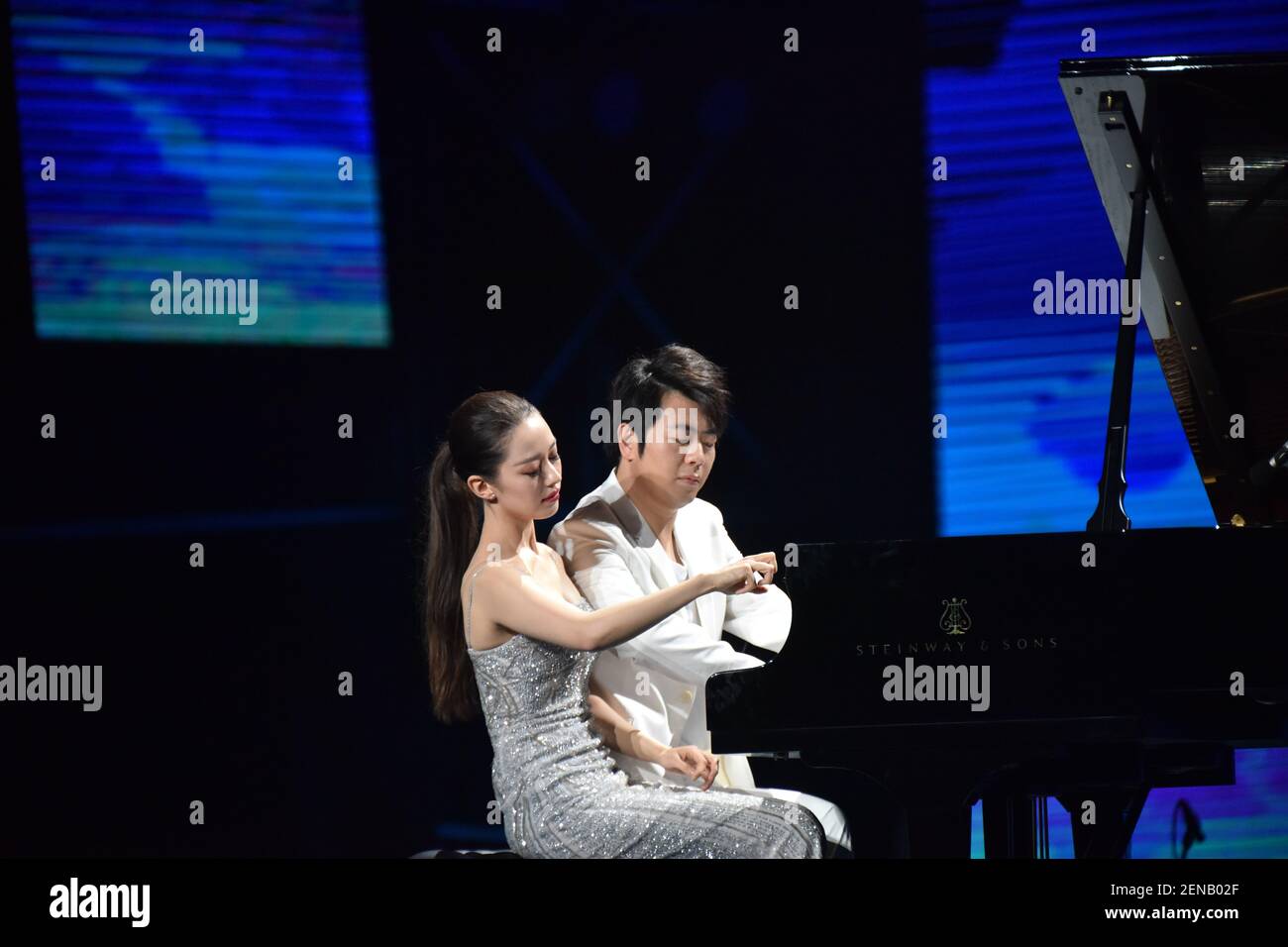 Chinese pianist Lang Lang and his wife Gina Alice Redlinger perform during a concert in Qingdao ...