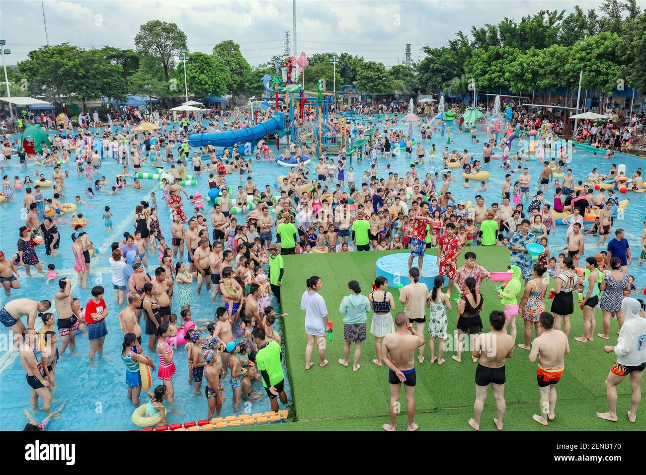 Chinese holidaymakers crowd a swimming pool at a water park on a ...