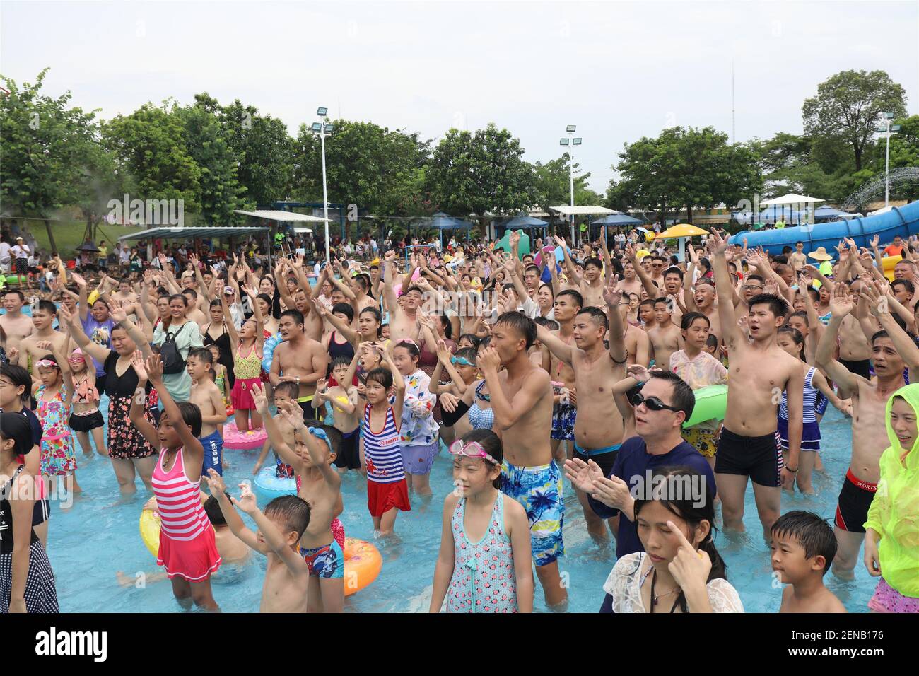 Chinese holidaymakers crowd a swimming pool at a water park on a ...