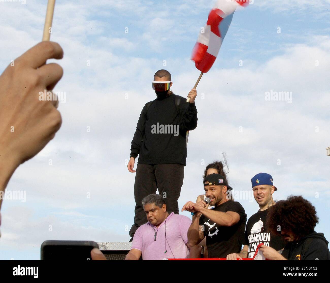 Singer Ricky Martin speaks to the crowd, accompanied by Puerto Rican ...