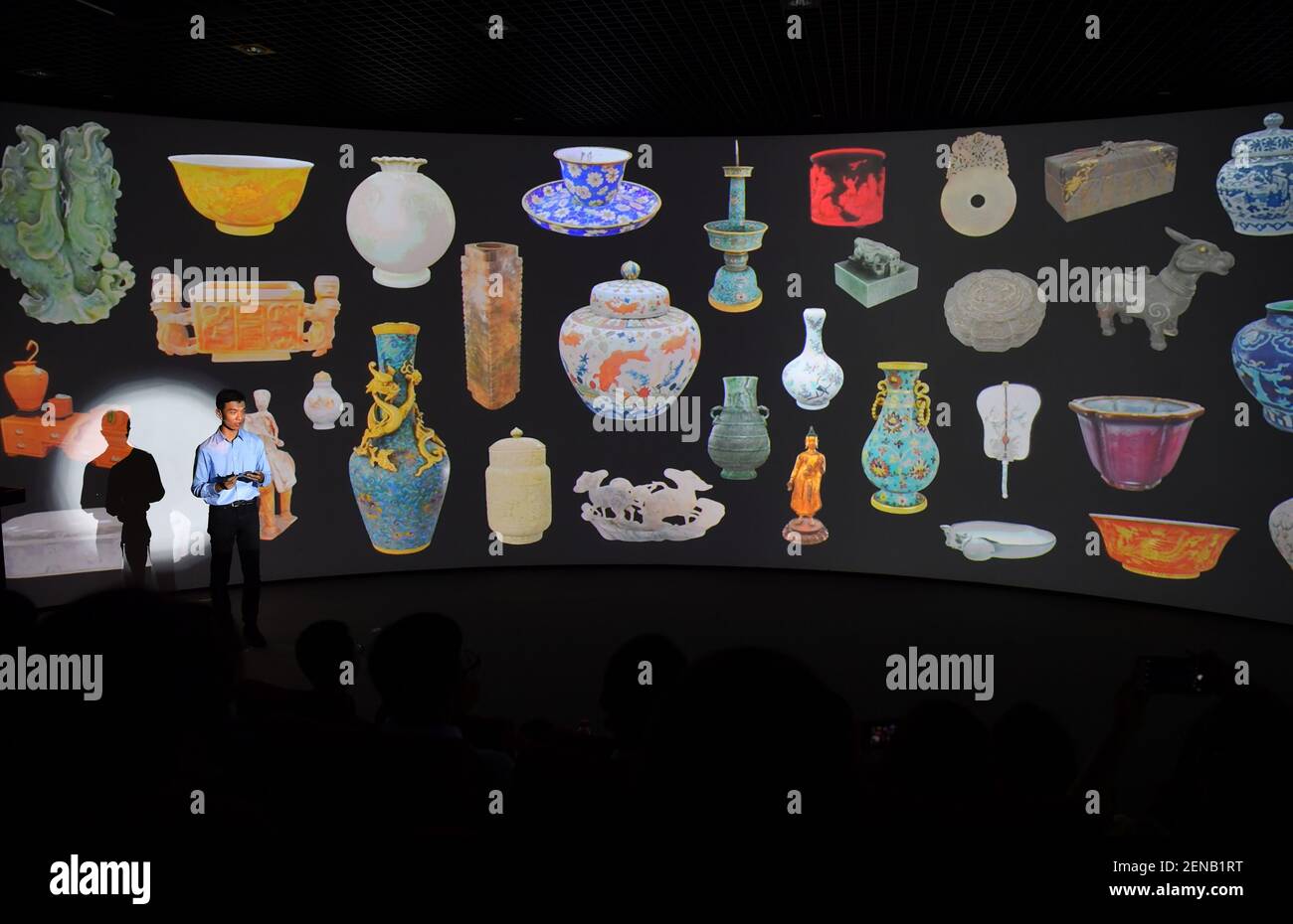 A staff member introduces new digital products at the Palace Museum ...