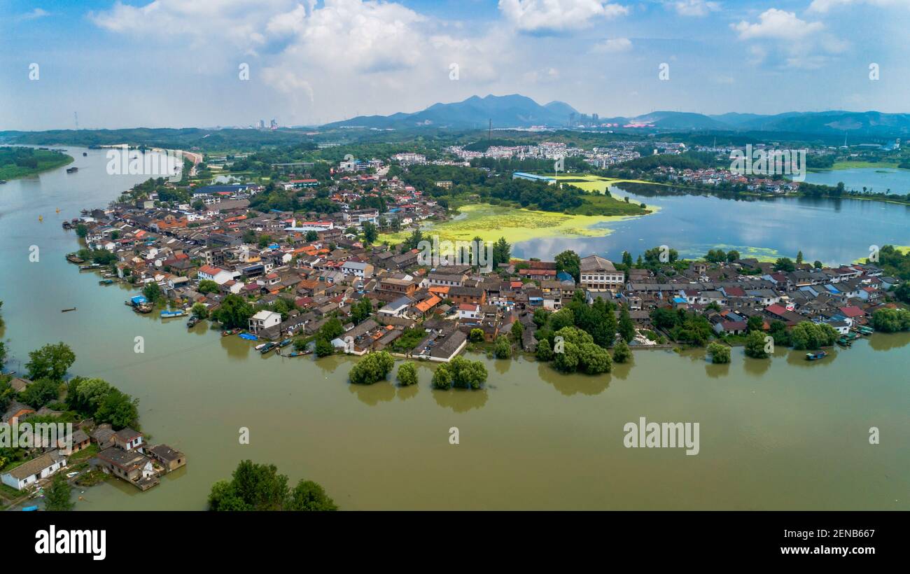 Aerial view of residential buildings an fields submerged by floodwater ...