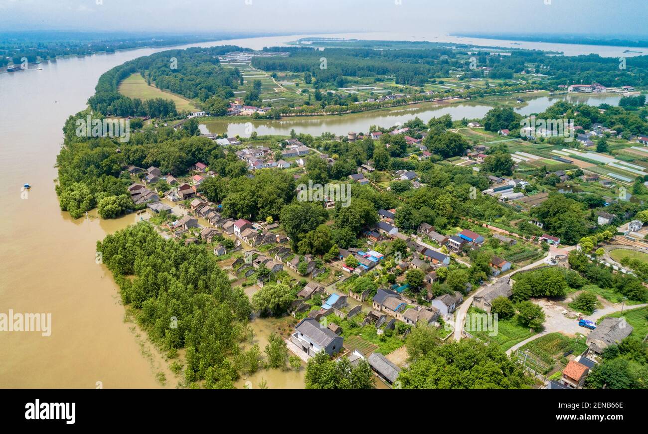 Aerial view of residential buildings an fields submerged by floodwater ...
