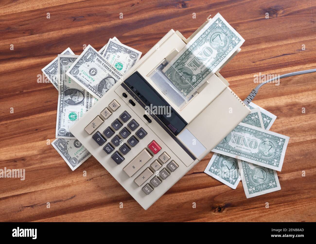 Old fashioned calculator and dollars on a desk Stock Photo - Alamy