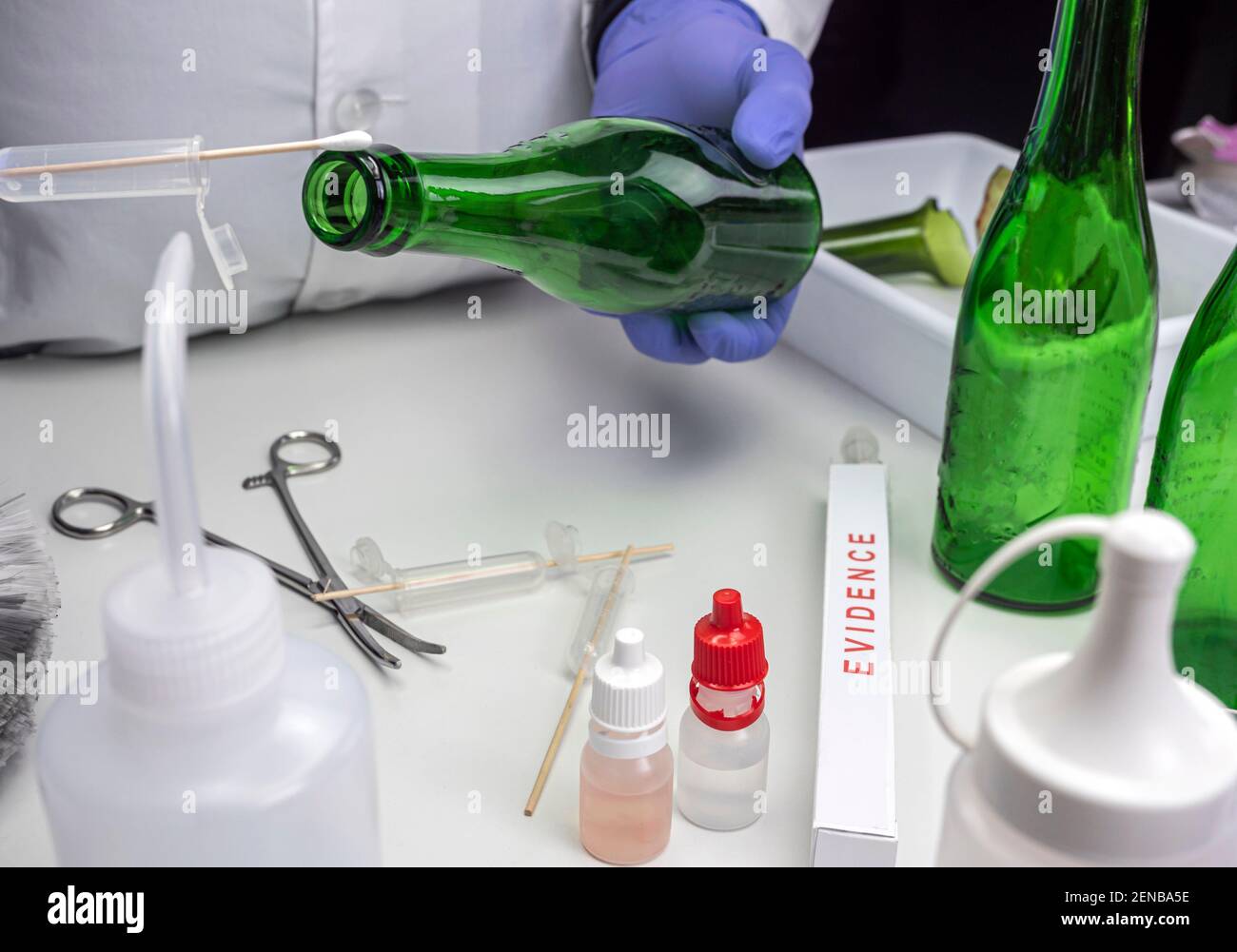 Police expert gets blood sample from a green glass bottle in ...