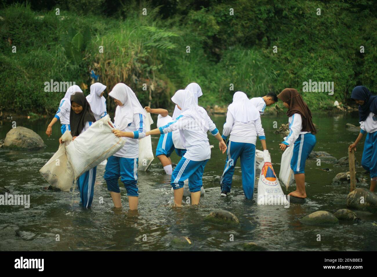 A number of Scouts clean up waste on the Ciliwung river in Bogor, West ...