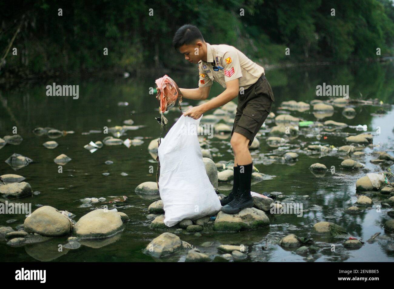 A number of Scouts clean up waste on the Ciliwung river in Bogor, West ...
