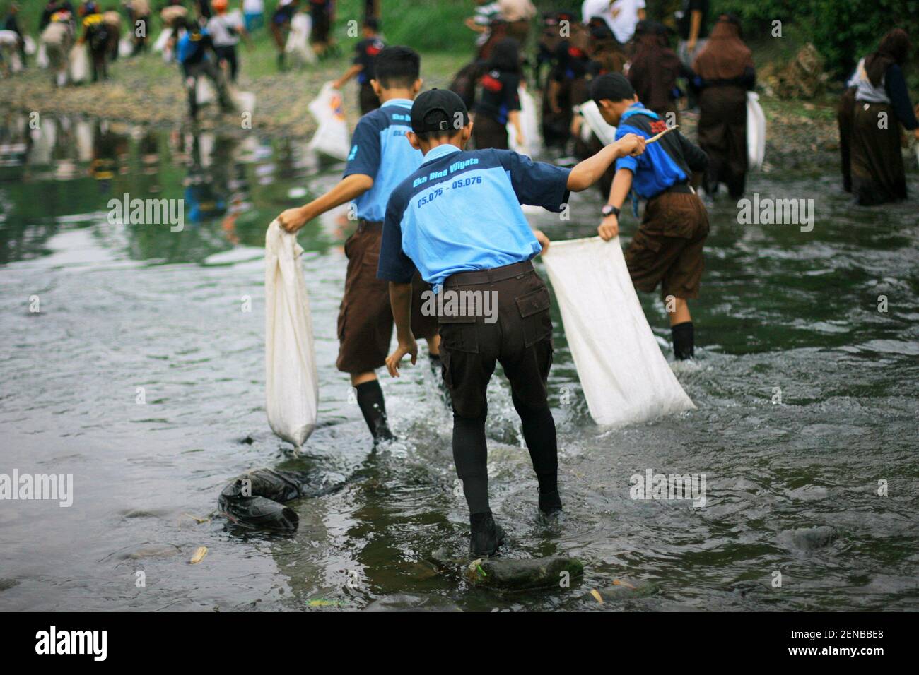 A number of Scouts clean up waste on the Ciliwung river in Bogor, West ...