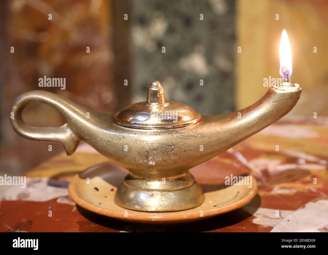 ancient golden oil lamp with flame to evoke the genie of the lamp Stock ...