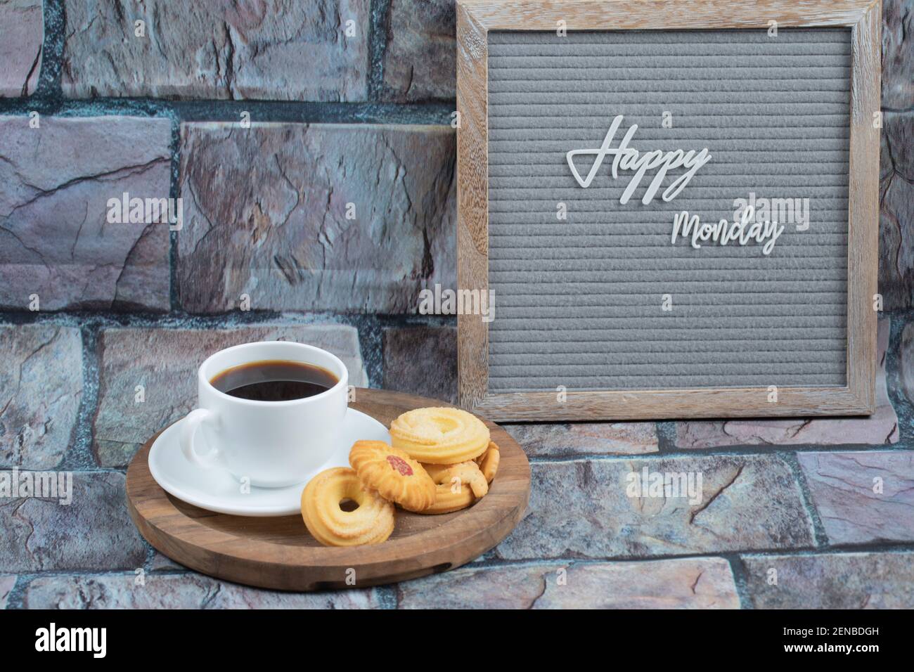 Happy monday poster with a cup of drink and cookies around Stock Photo ...