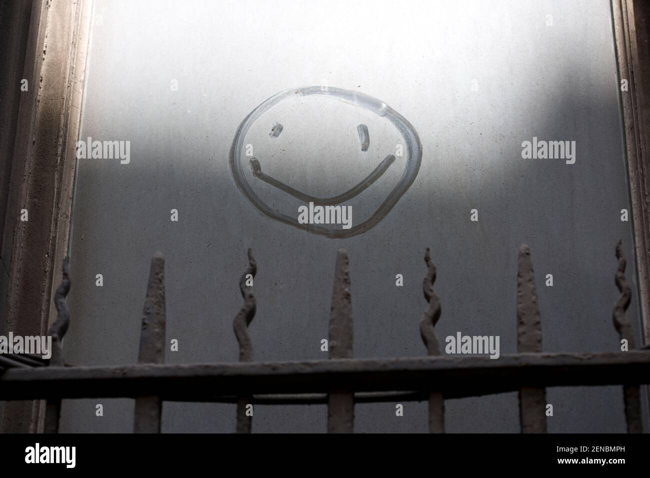 Smiley face drawn on a dirty window Stock Photo - Alamy