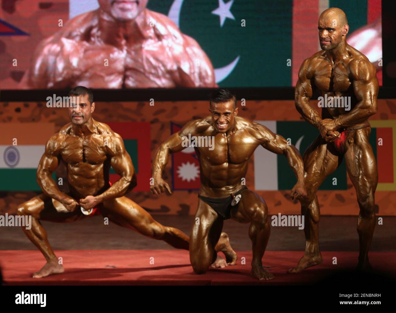 Bodybuilders pose during the 12th South Asian Bodybuilding Championship ...