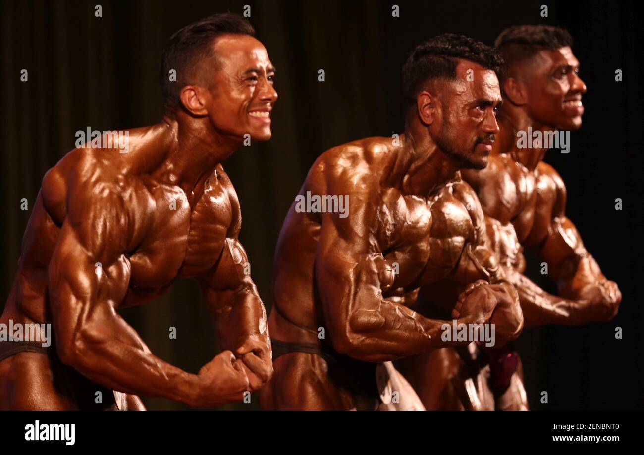 Bodybuilders pose during the 12th South Asian Bodybuilding Championship ...