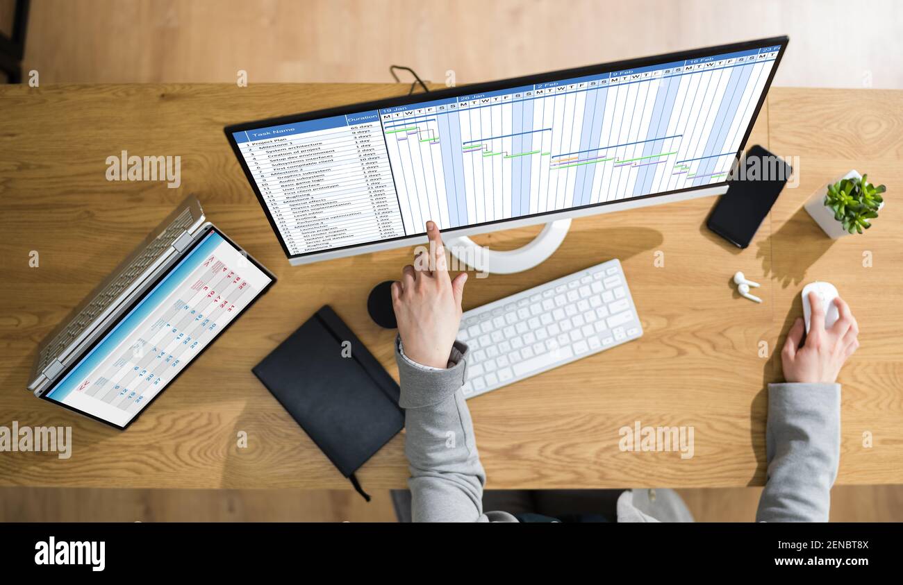 Employee Looking Calendar Schedule On Computer Screen Stock Photo - Alamy