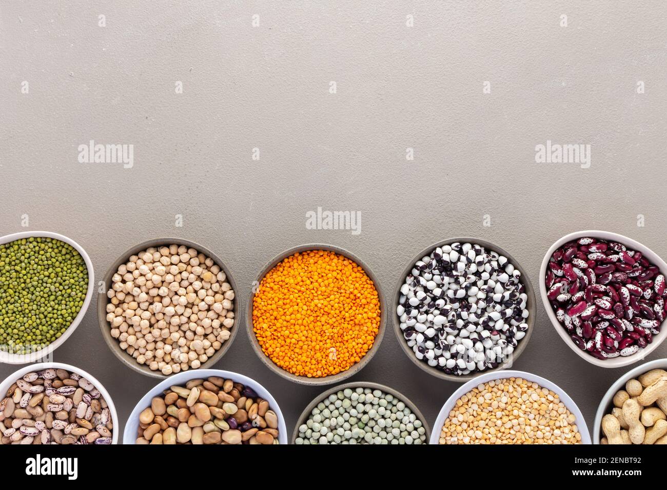 Different types of legumes in bowls, green and yellow peas, chickpeas ...