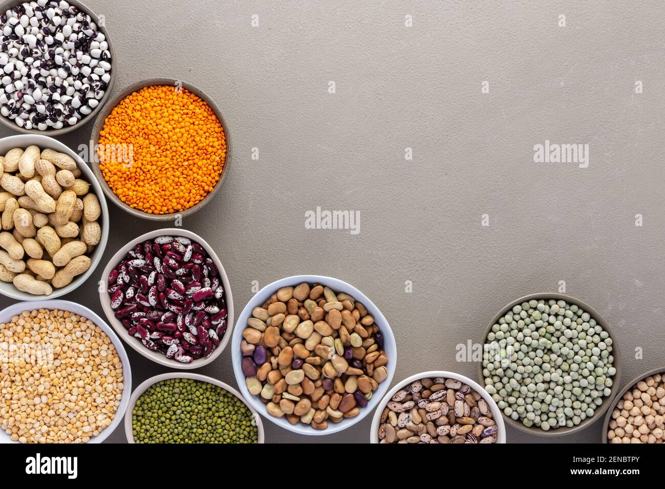 Different types of legumes in bowls, green and yellow peas, chickpeas ...