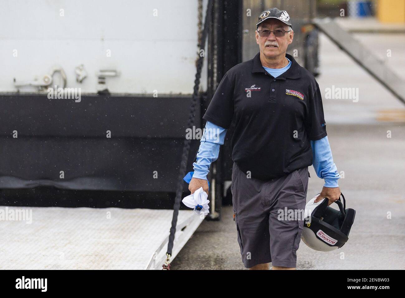 Randy Lanier, 64, carries a student's helmet during his weekend job as ...