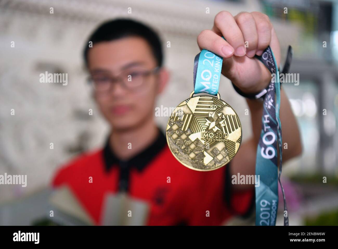 A high-school student from team China shows his gold medal at the Beijing Capital International ...