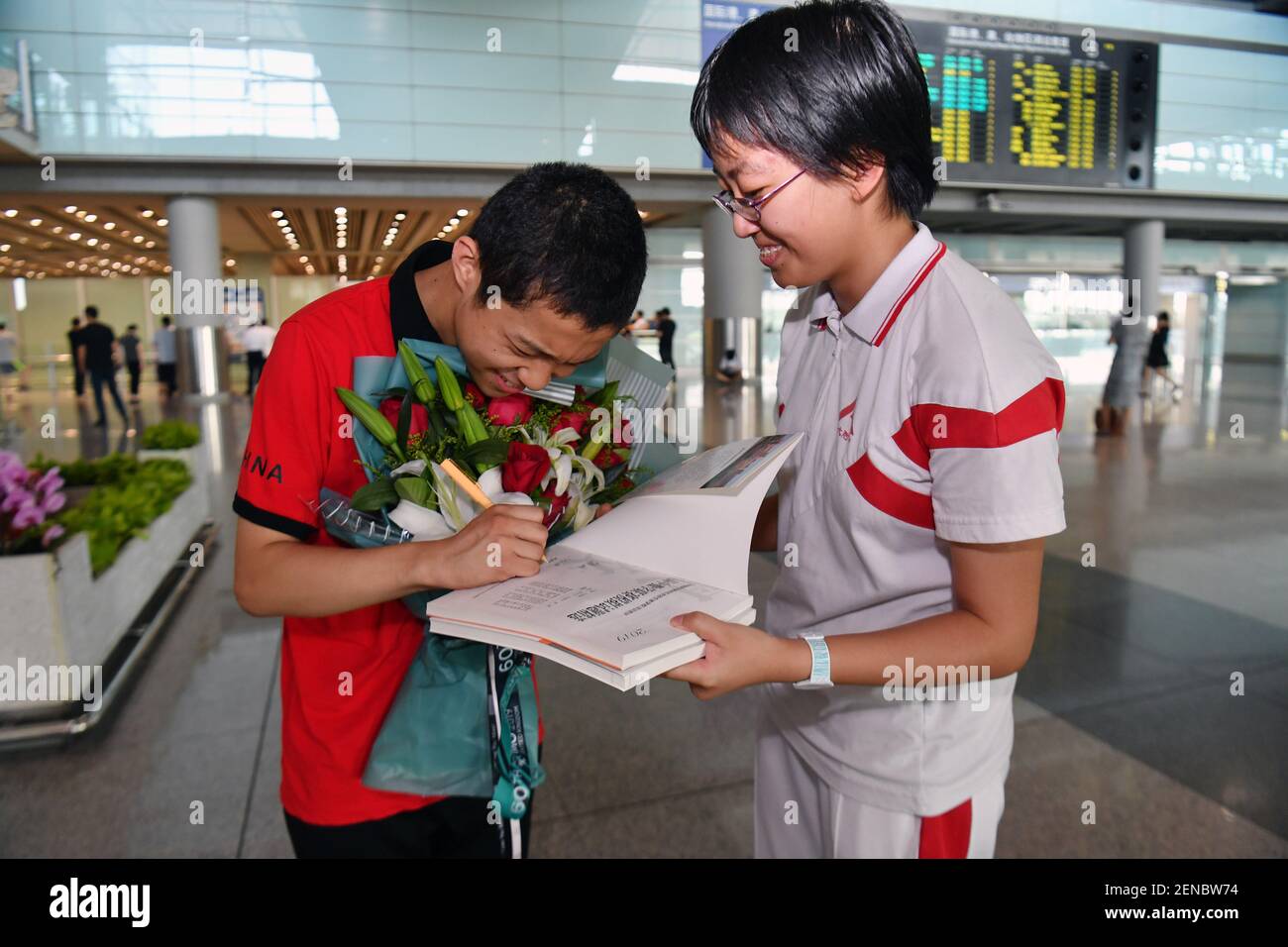 A high-school student from team China arrives at the Beijing Capital ...