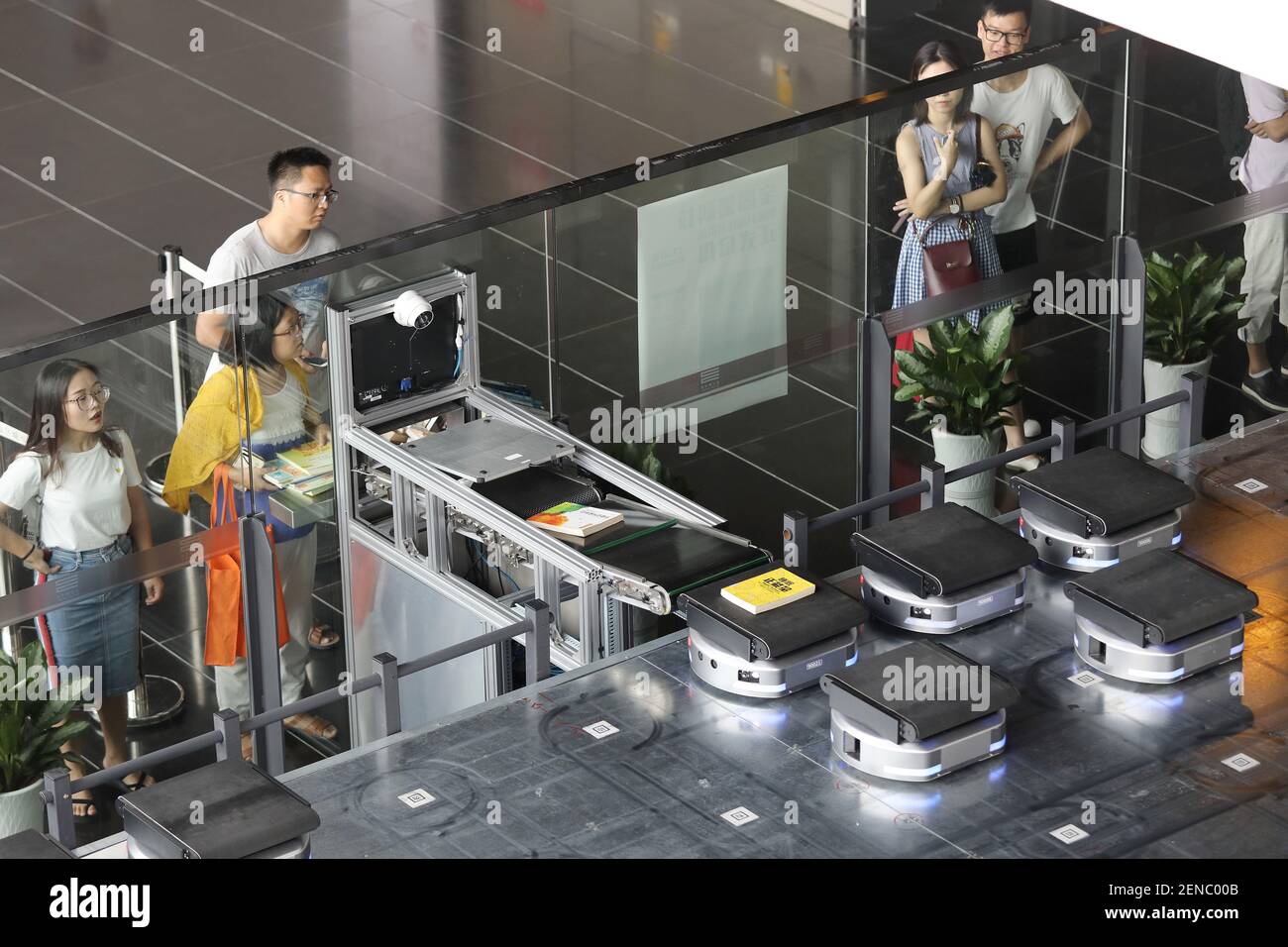 Readers experience robots in Shenzhen Baoan Library which helps them ...