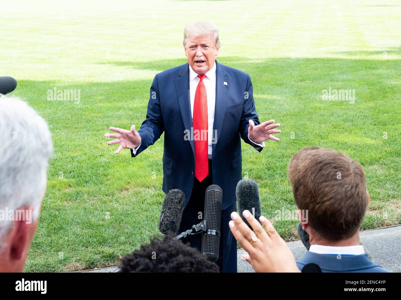 President Donald Trump talking with the press as he leaves the White ...