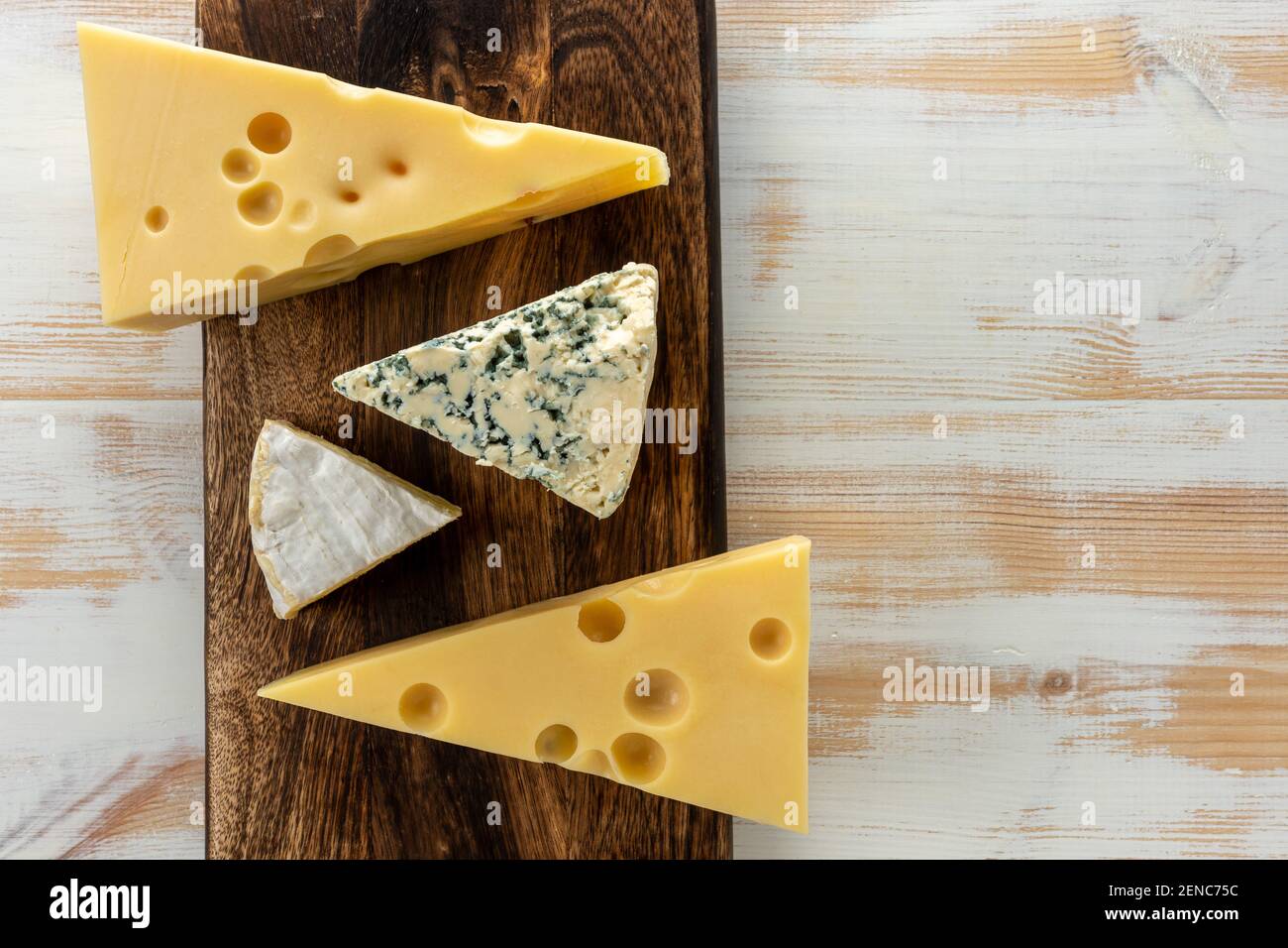 Assortment of different cheese types on white wooden table. Cheese ...