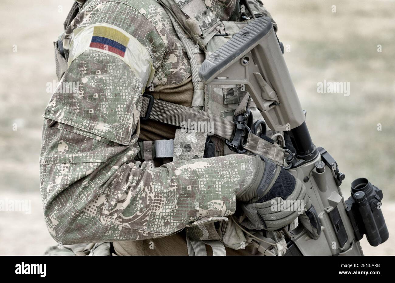 Soldier with assault rifle and flag of Colombia on military uniform ...