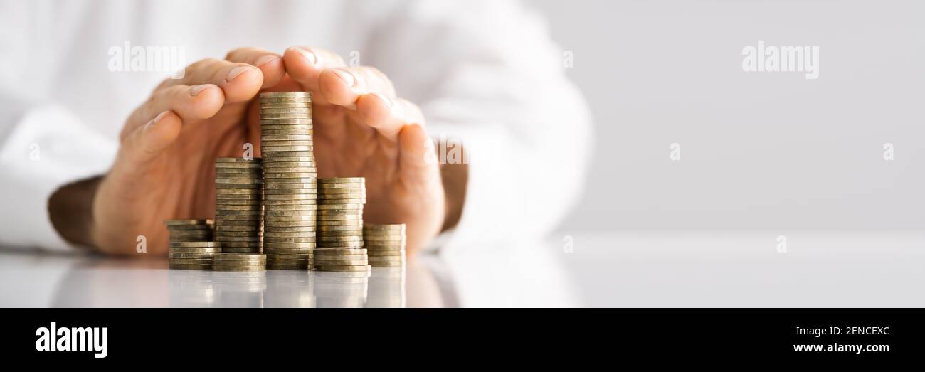 Save Business Money. Employee Protecting Budget Pile Stock Photo - Alamy