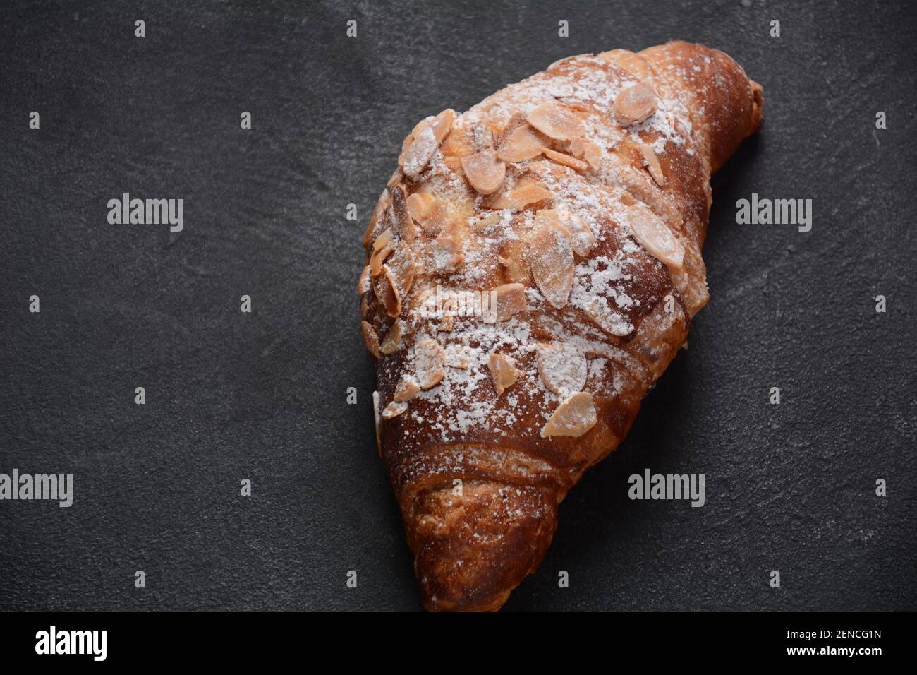Traditional French breakfast croissant with almonds on white background ...