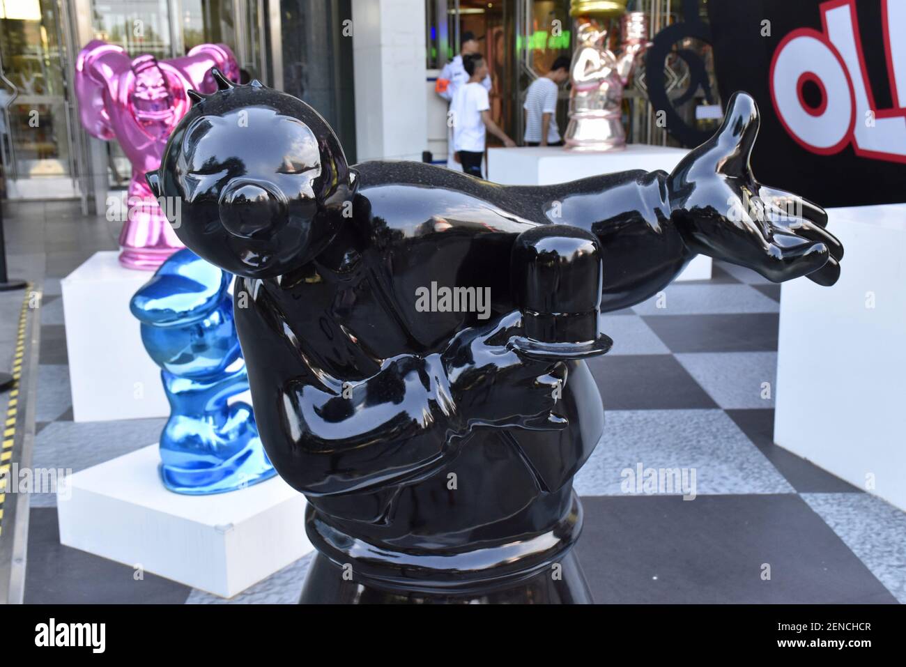 Customers view sculptures featuring cartoon character "Popeye the ...