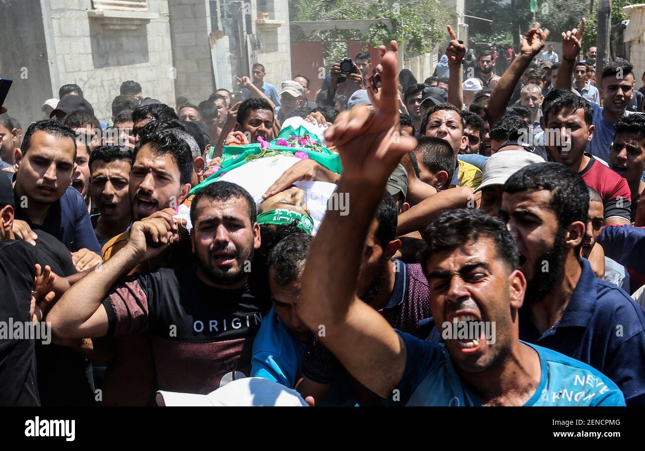 Mourners carry the body of Ahmed al-Qarra, 23, during his funeral in ...