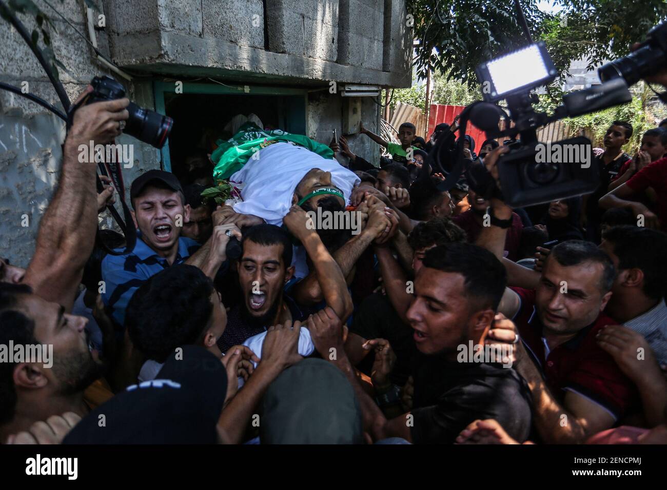 Mourners carry the body of Ahmed al-Qarra, 23, during his funeral in ...