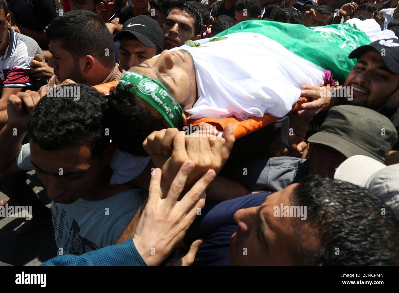 Mourners carry the body of Ahmed al-Qarra, 23, during his funeral in ...