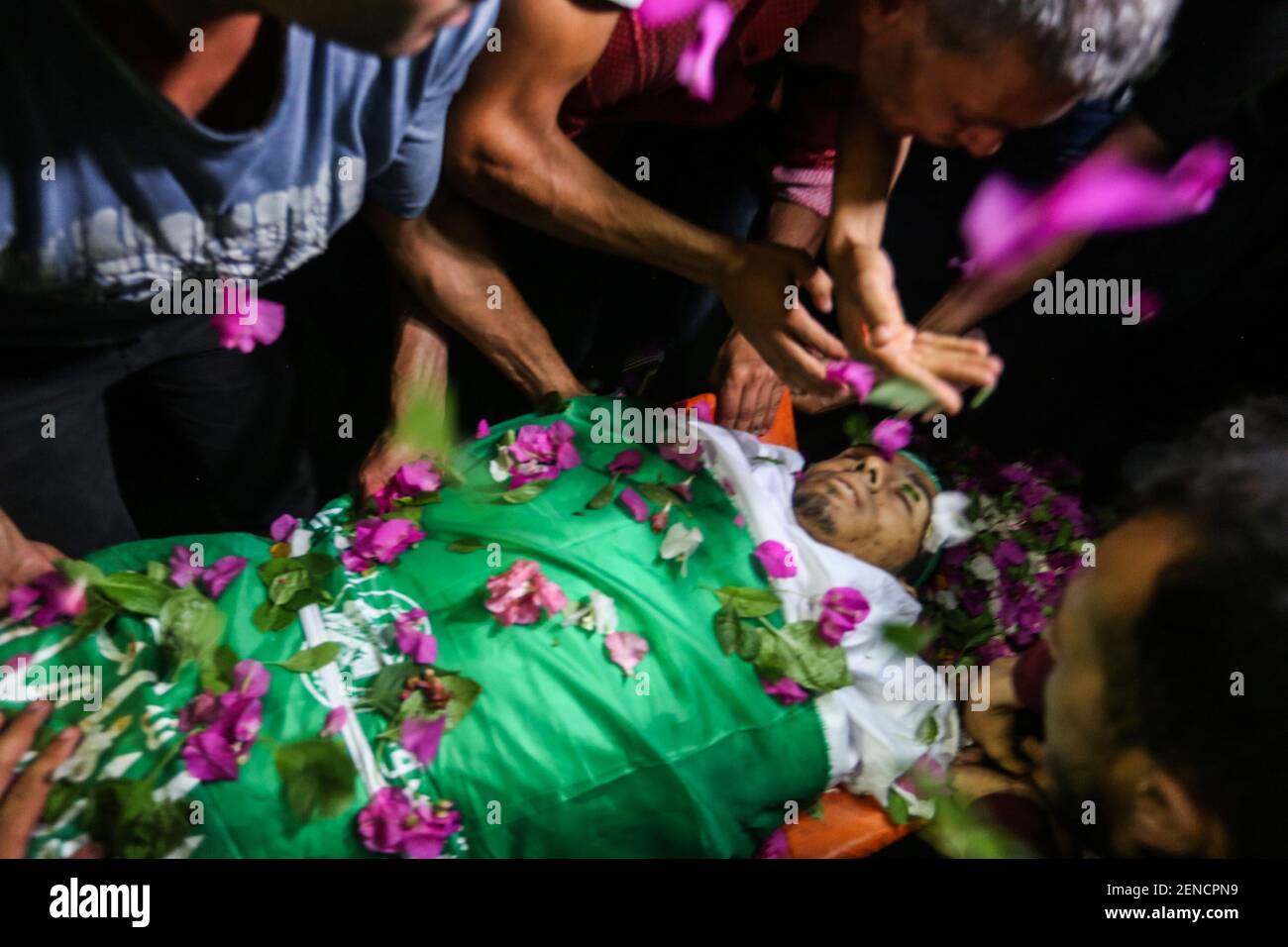 Relatives mourns of Ahmed al-Qarra, 23, during his funeral in town of ...
