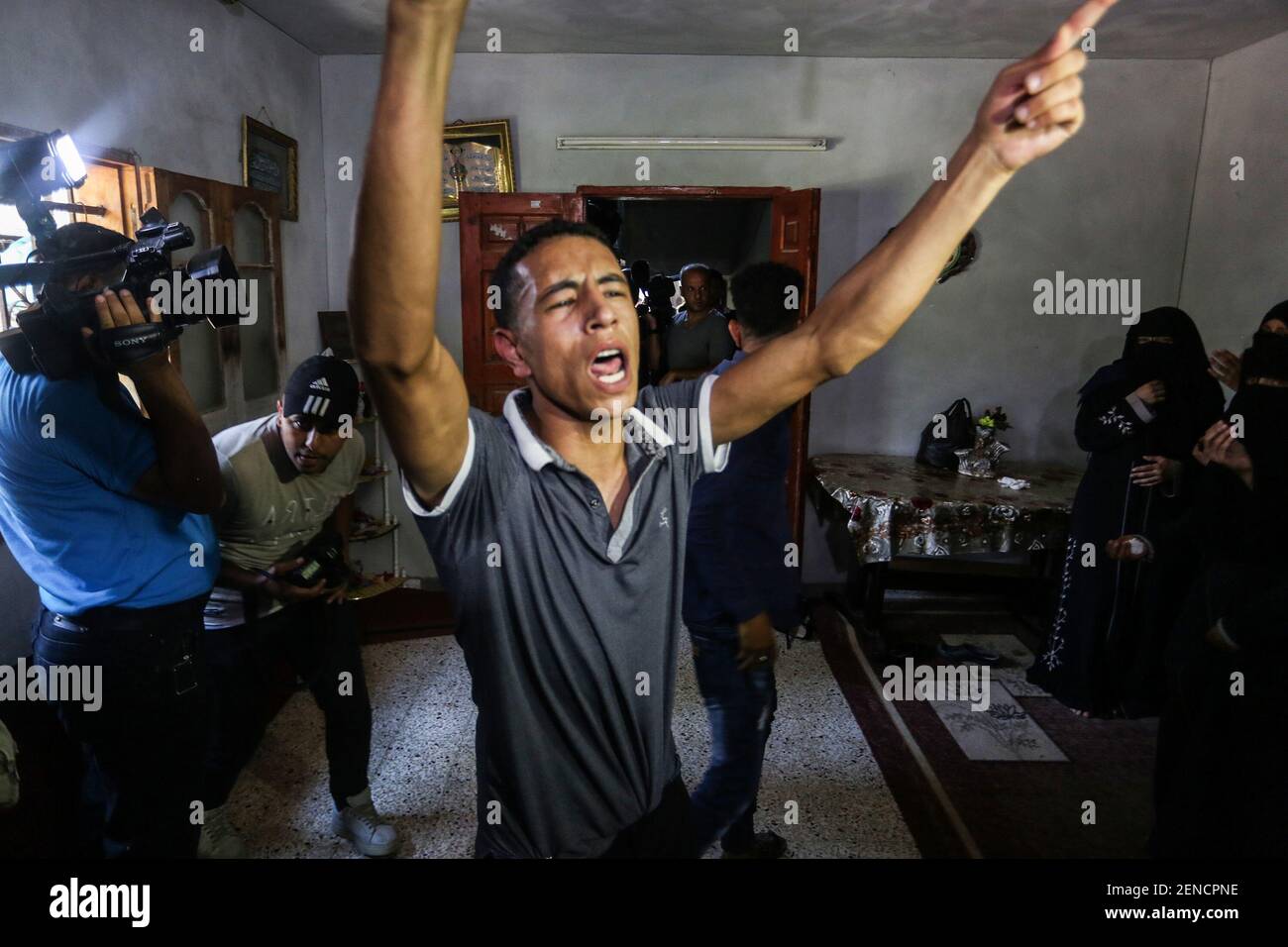 Relatives mourns of Ahmed al-Qarra, 23, during his funeral in town of ...