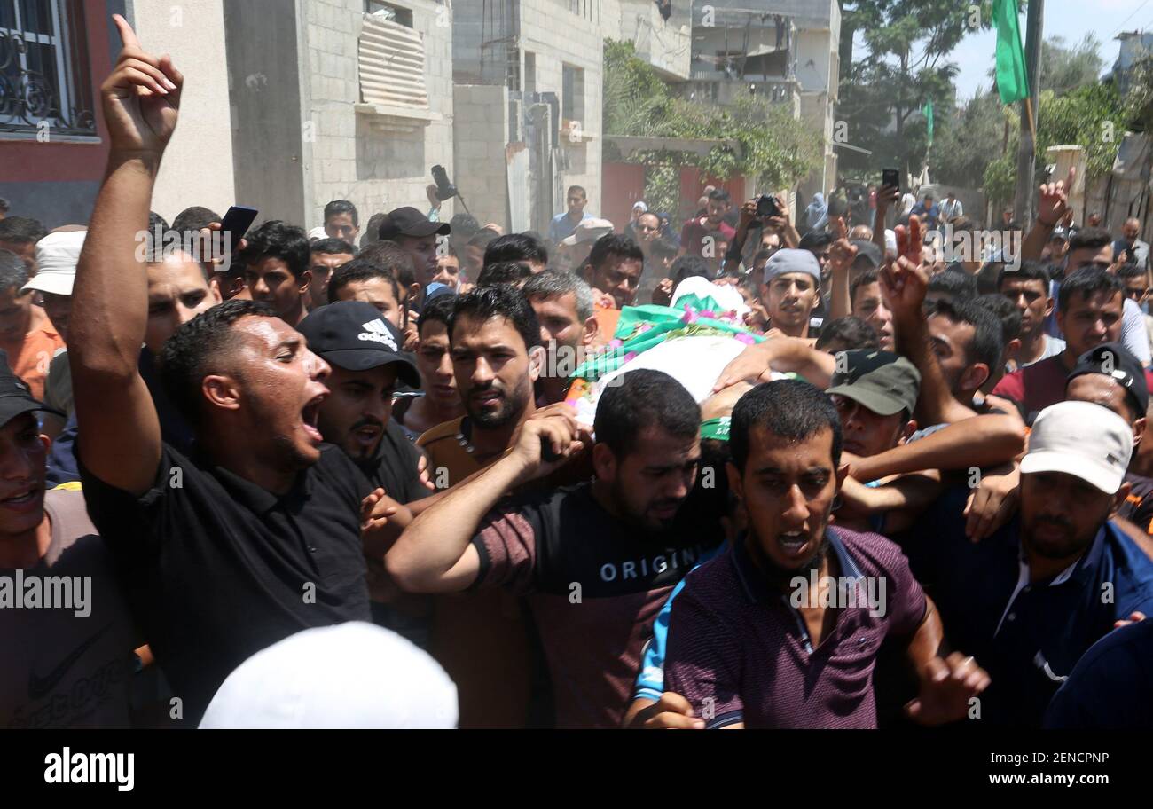 Mourners carry the body of Ahmed al-Qarra, 23, during his funeral in ...