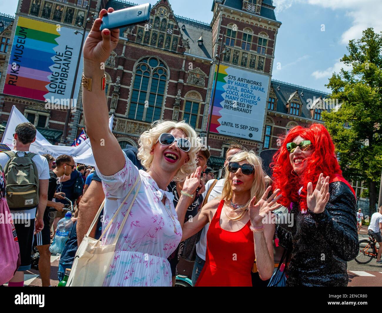 Three men in women clothes take a selfie during the Pride Walk. Because ...