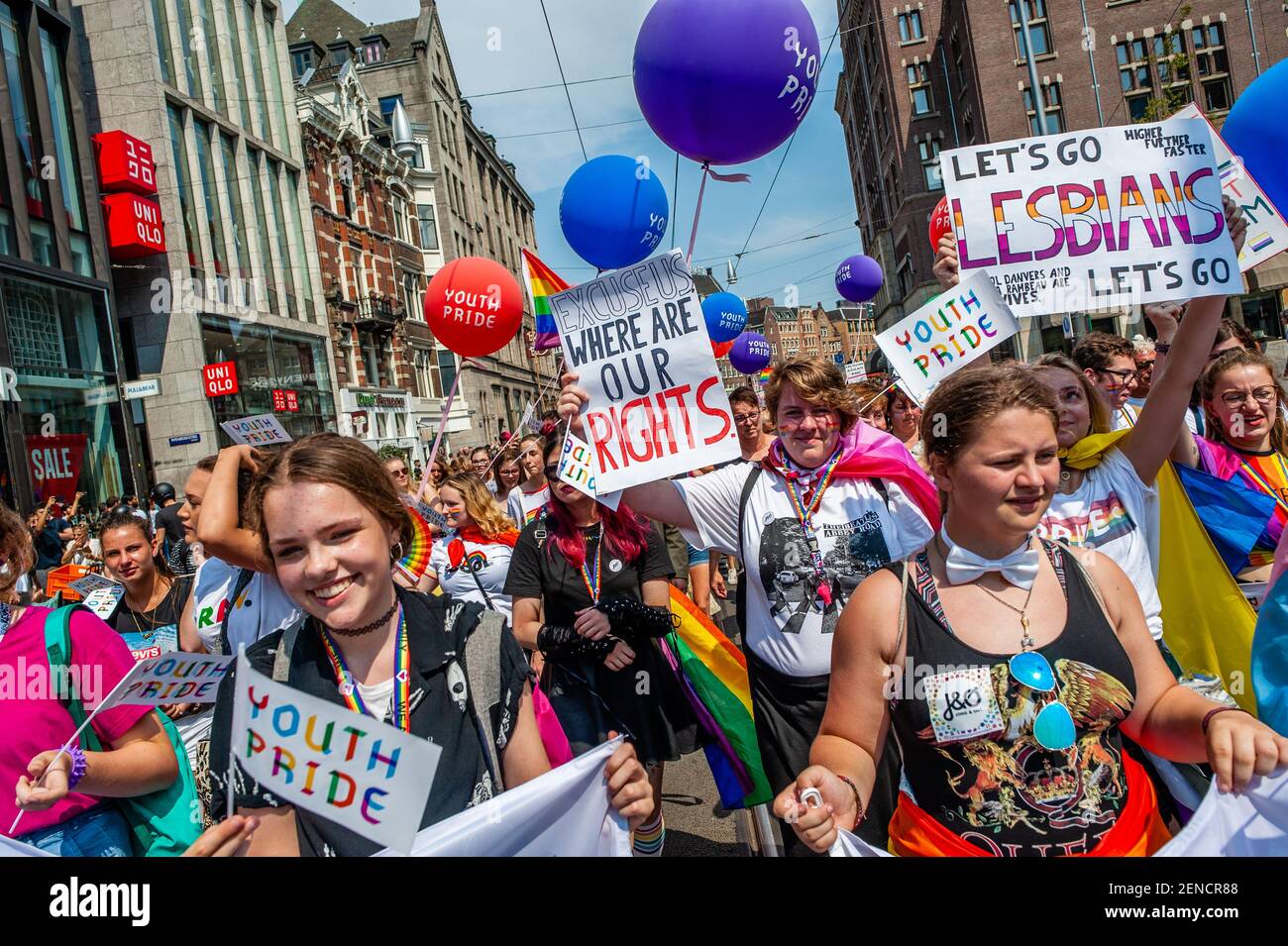 A group of young people hold placards during the Pride Walk. Because of ...