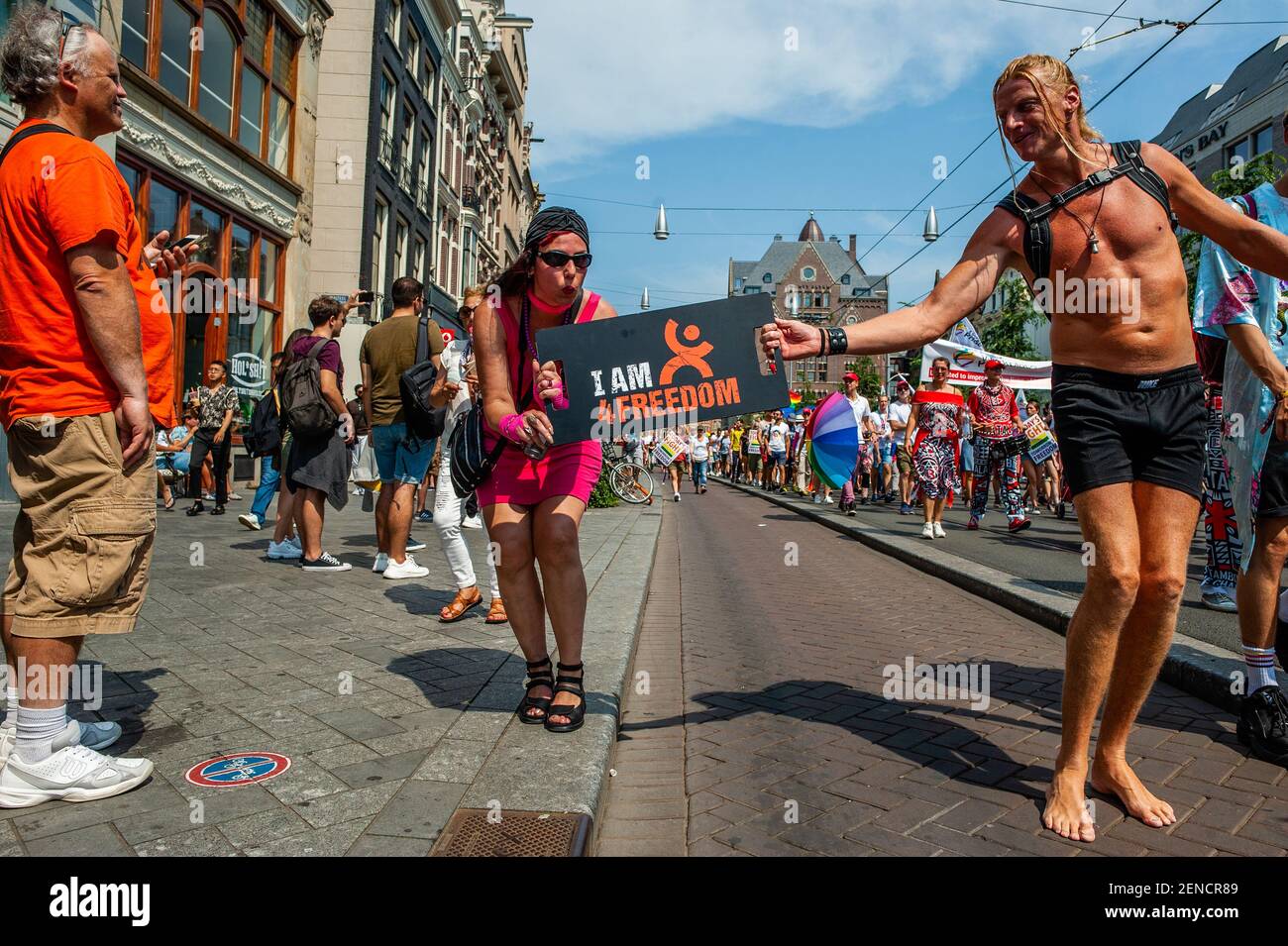 A man and a woman hold a placard that says, I am 4 freedom, during the ...